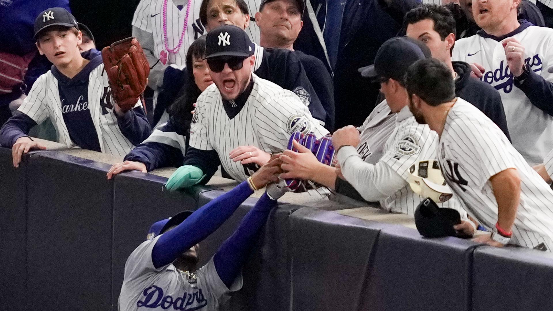 Fans try to rip ball from Dodgers player's glove, get ejected | kgw.com