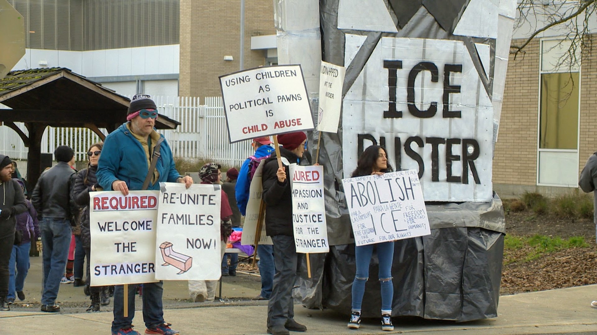 Protesters dress as superheroes outside Portland's ICE headquarters ...