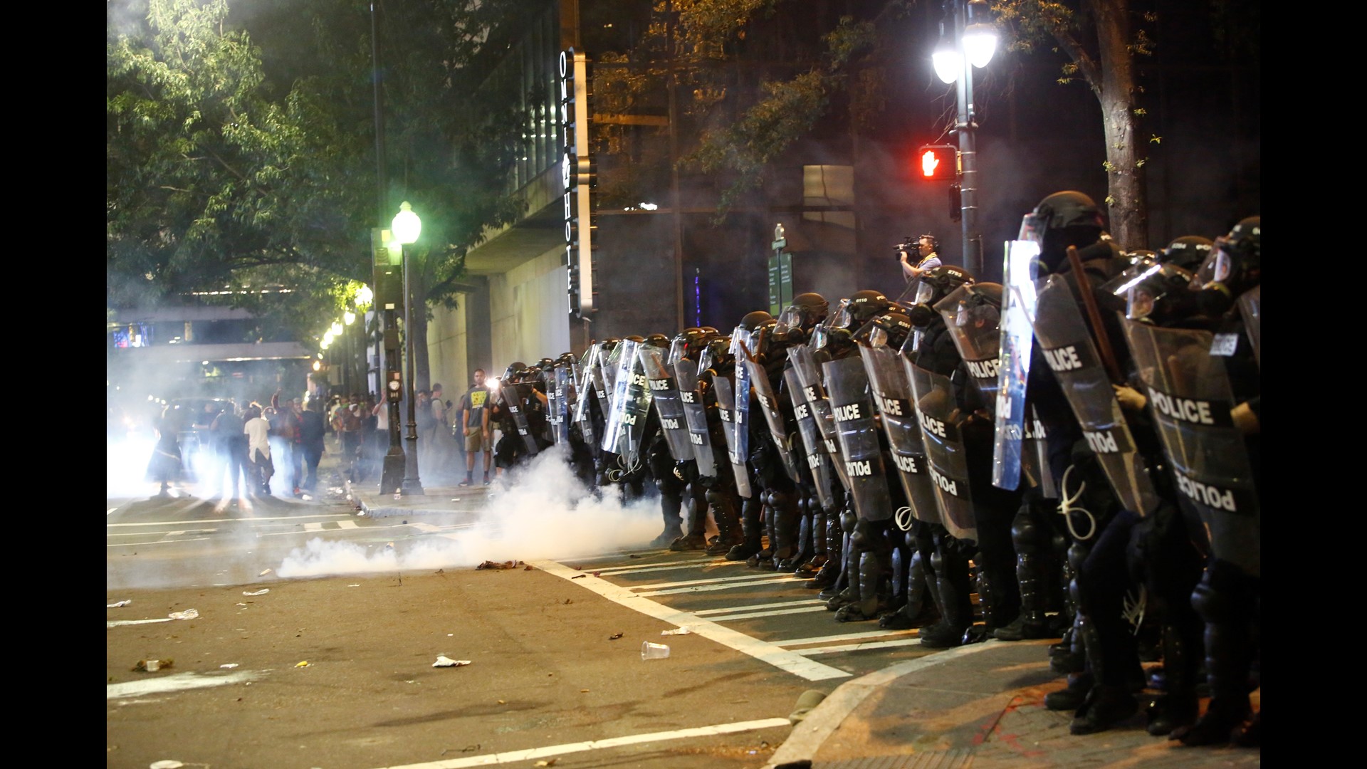 Man gives police in riot gear hugs | kgw.com