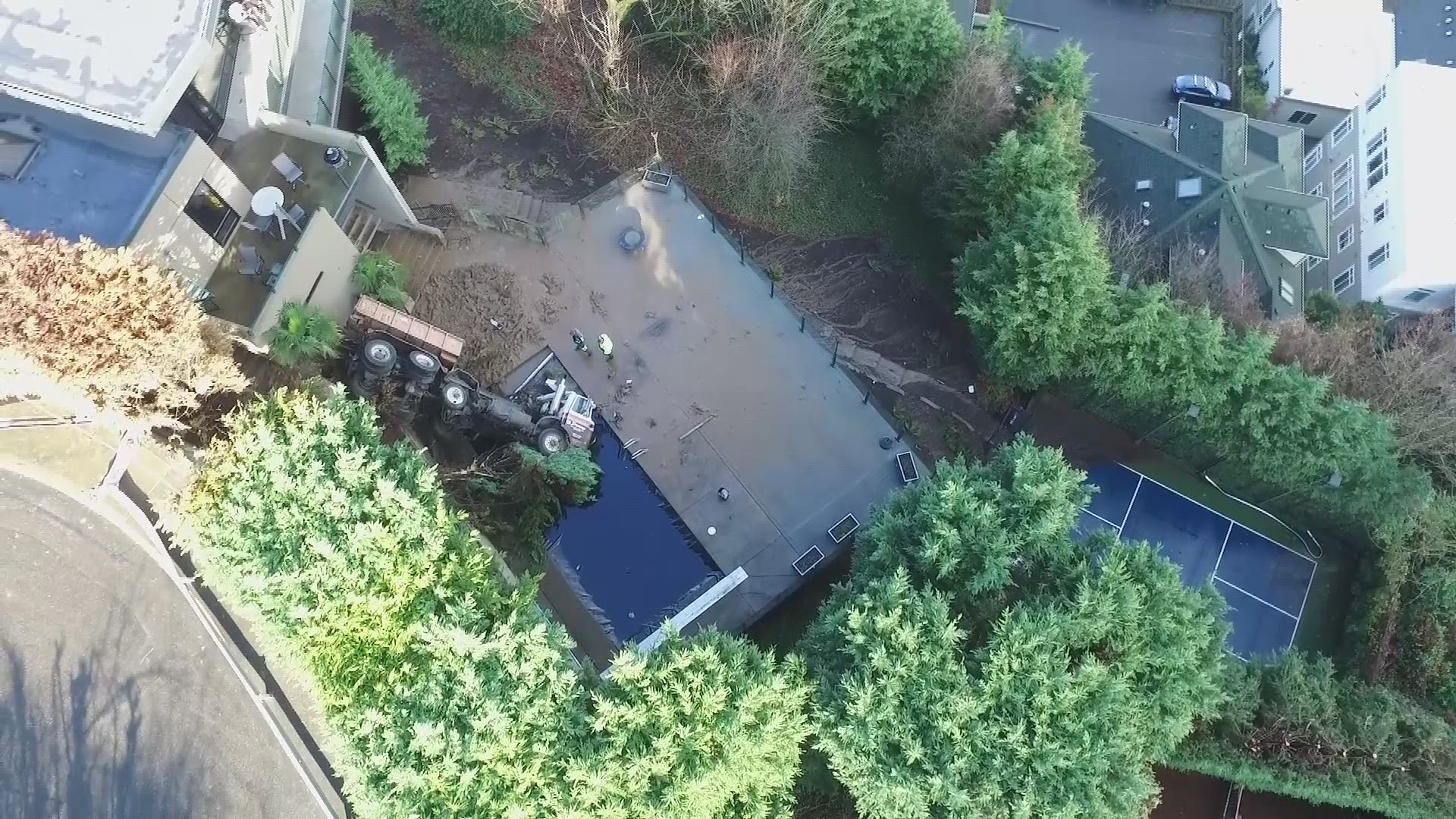 Driver rescued after large truck crashes into Evan Turner's pool | kgw.com
