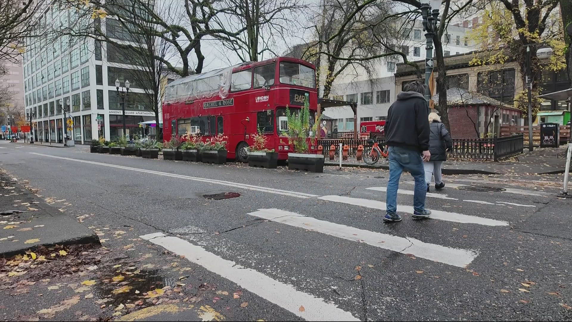 Double-decker bus serves customers at the curb in downtown Portland ...