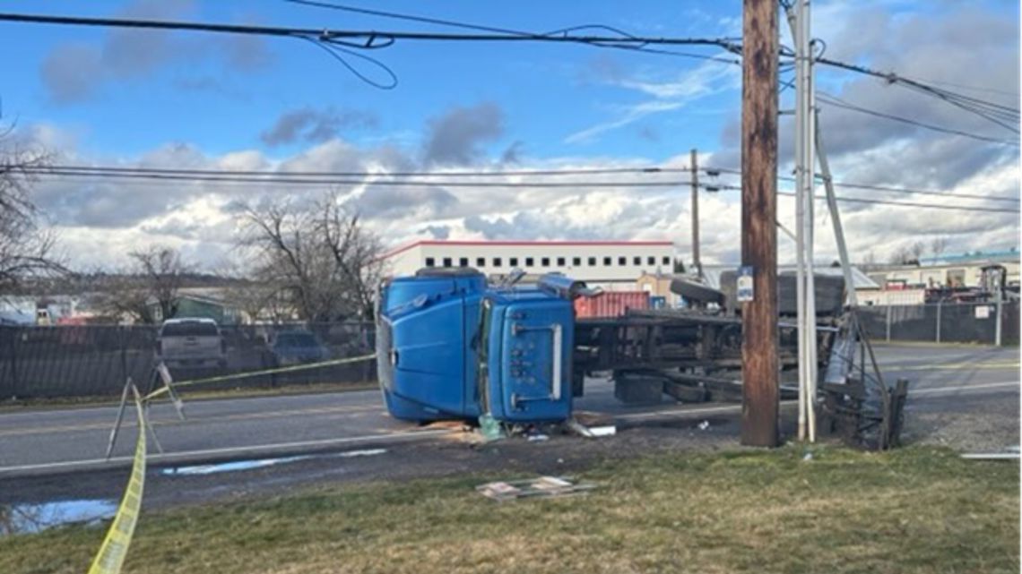 Truck tips over after snagging power lines, road closed | kgw.com
